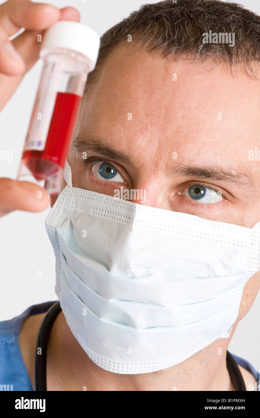 Close up of a male doctor looking at a blood sample Stock Photo - Alamy