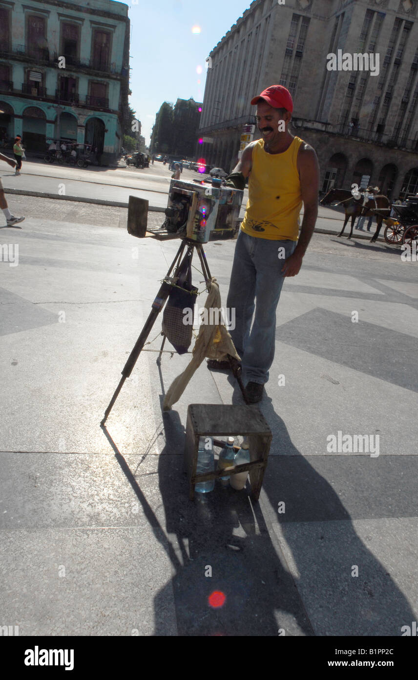 street photographer busking for tourist pictures on pinhole camera ...