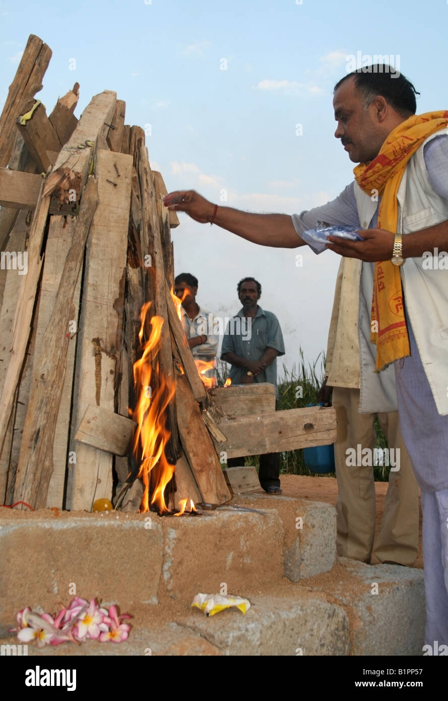 Priest lights the holika fire for the Holika fire ceremony , Holi ...