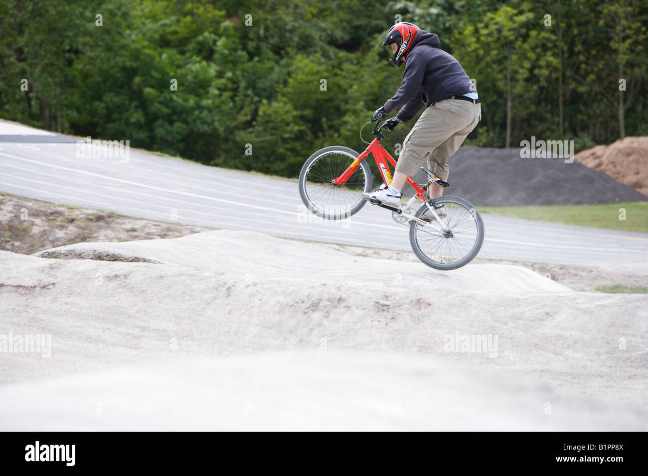 BMX cyclist cycling on a track Stock Photo - Alamy