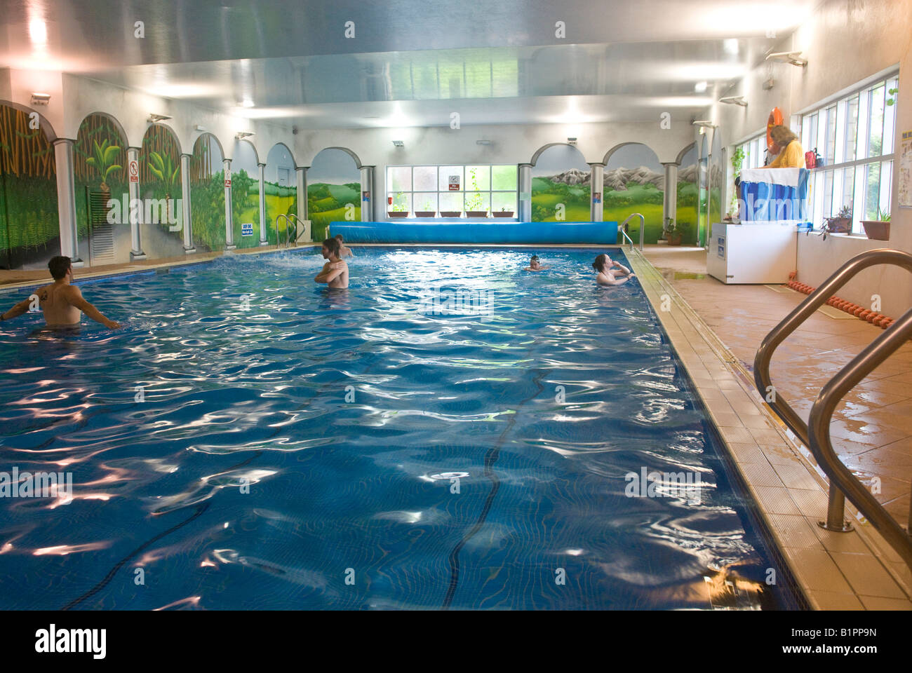 large indoor swimming pool with swimmer Stock Photo - Alamy