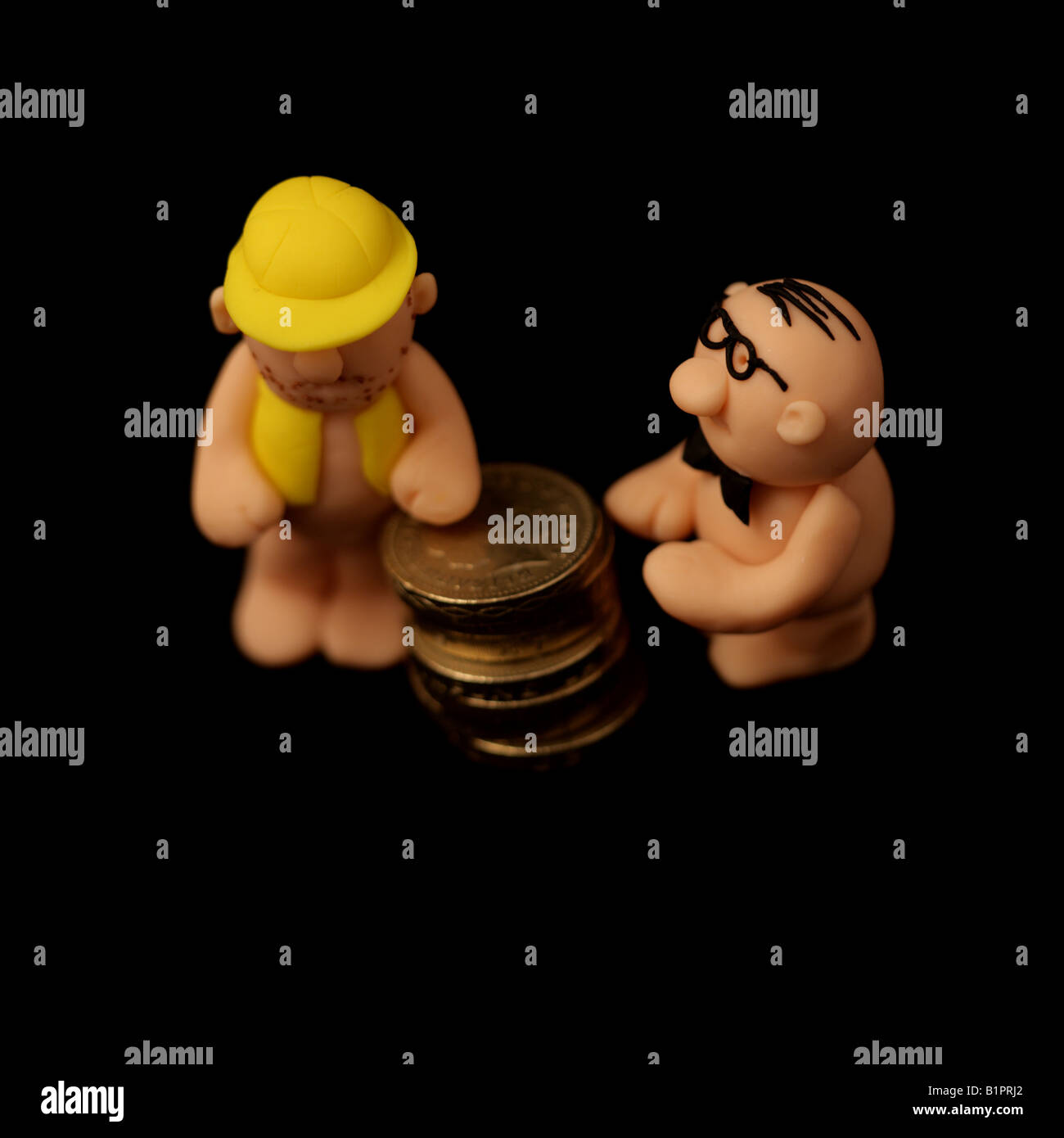 figures: worker and manager exchange cash Stock Photo - Alamy