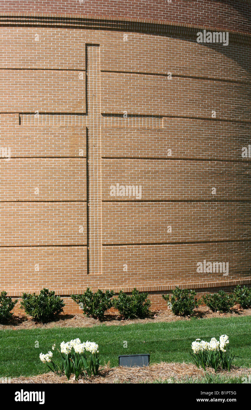 A brick wall of a church with a cross embedded Stock Photo - Alamy