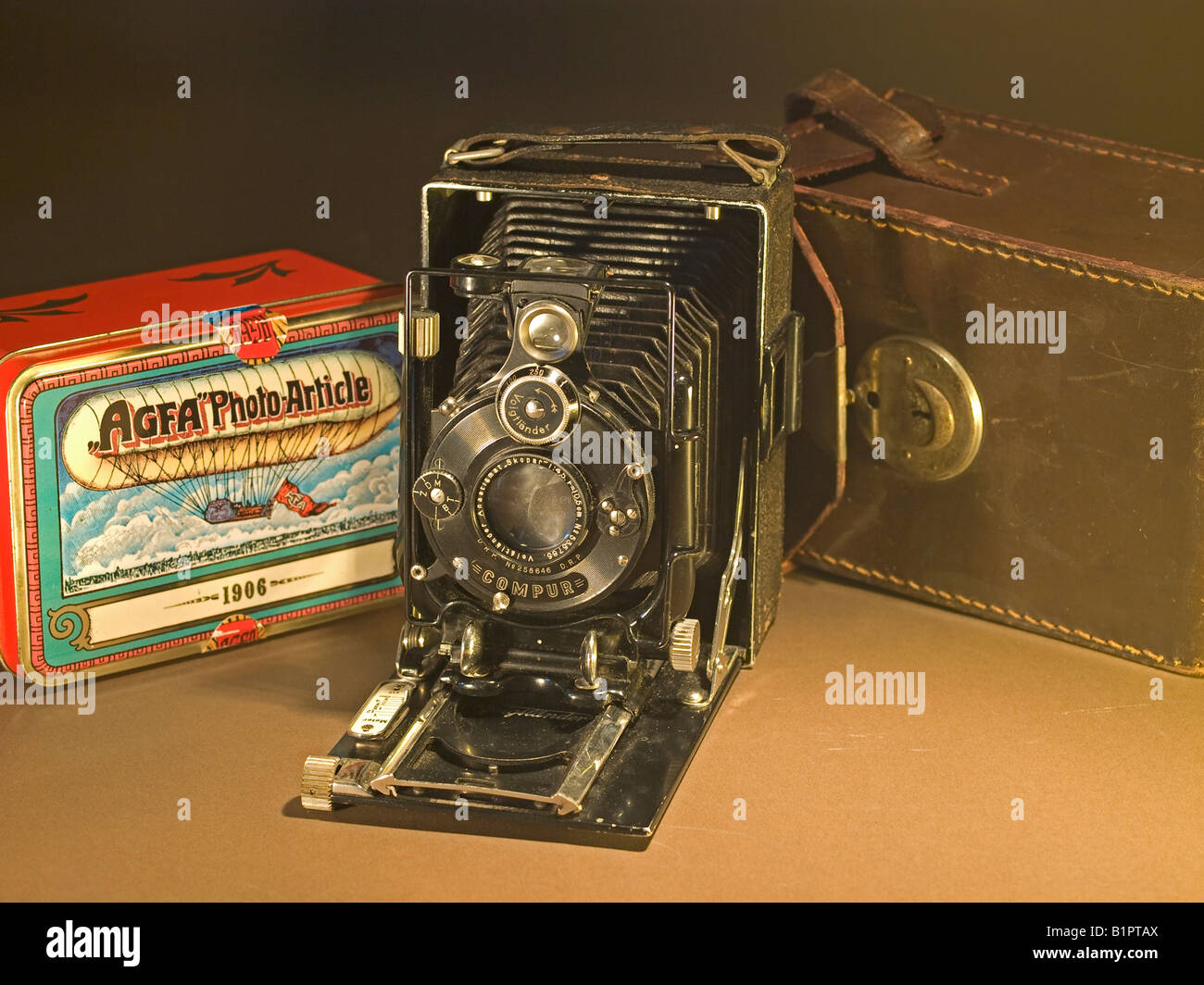 old tin for Films Agfa with a historic camera Voigtländer from about ...