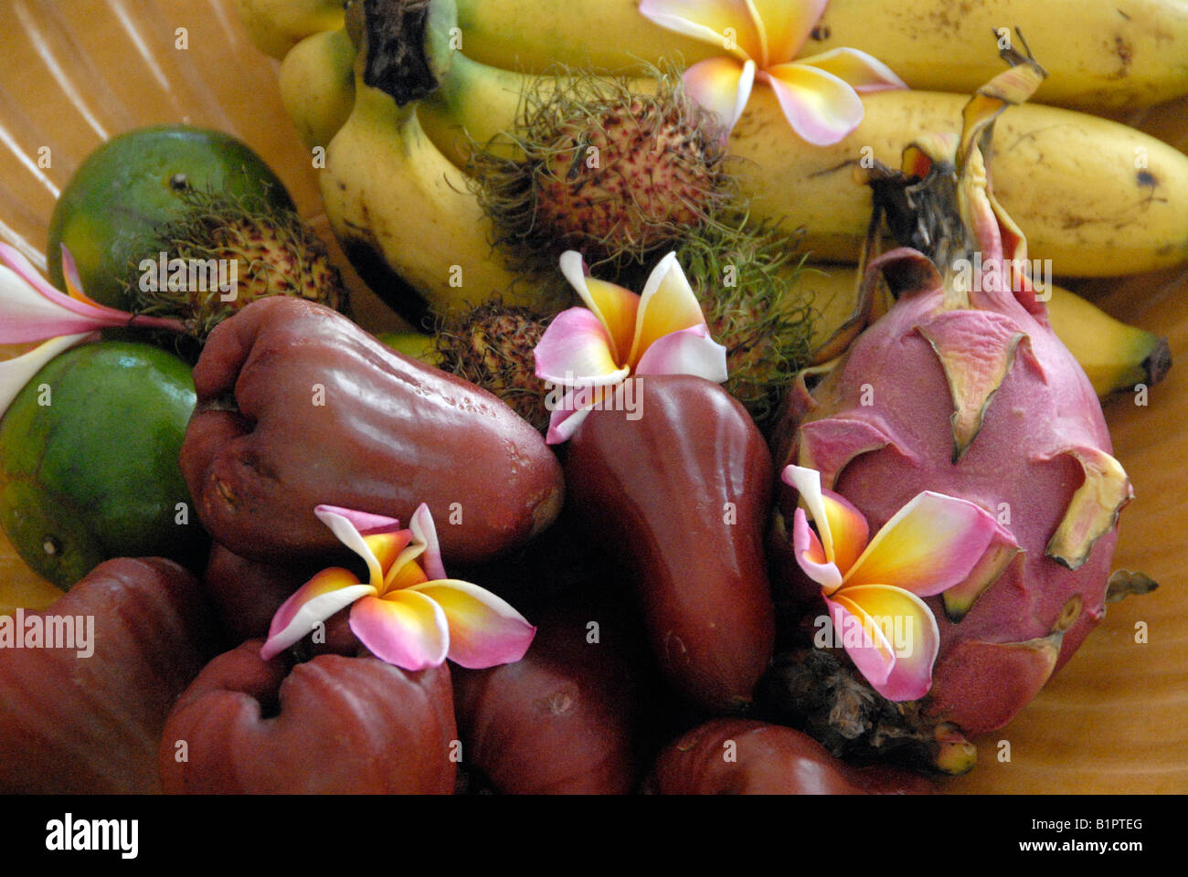Tropical fruit and orchid flowers Stock Photo - Alamy