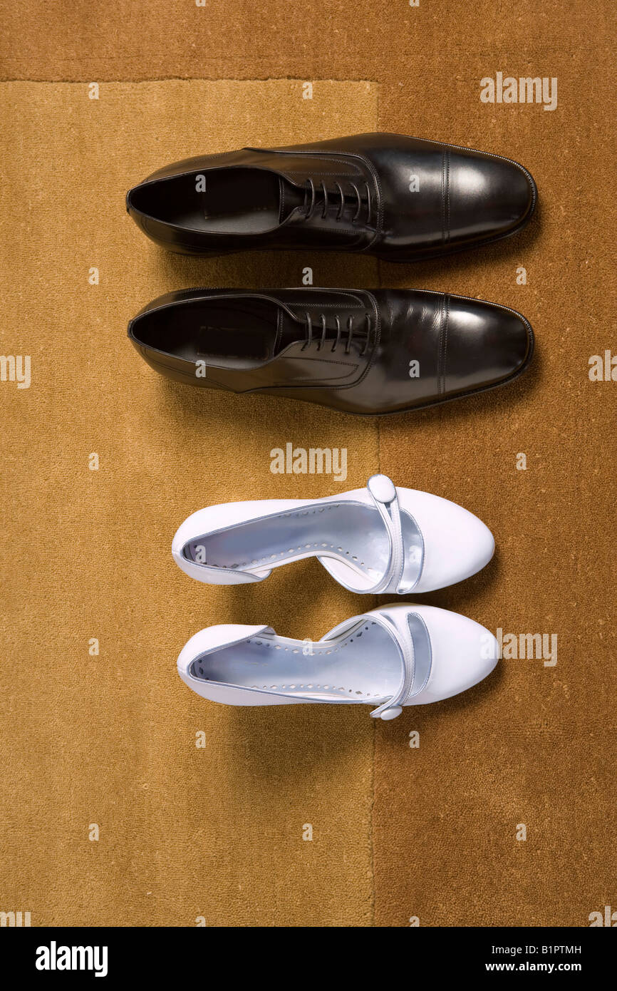 two pairs of shoes on carpet Stock Photo - Alamy