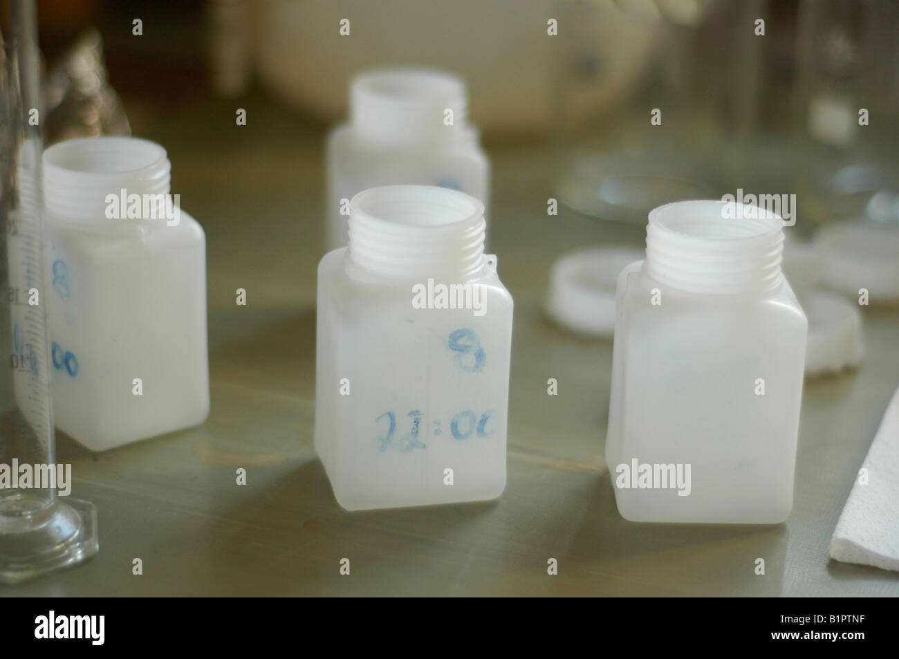 A shot of a group of chemical bottles and containers in a laboratory ...