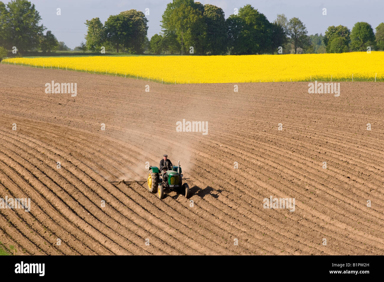 Farmer in a tractor cultivating his land Kaszuby region Poland Stock ...