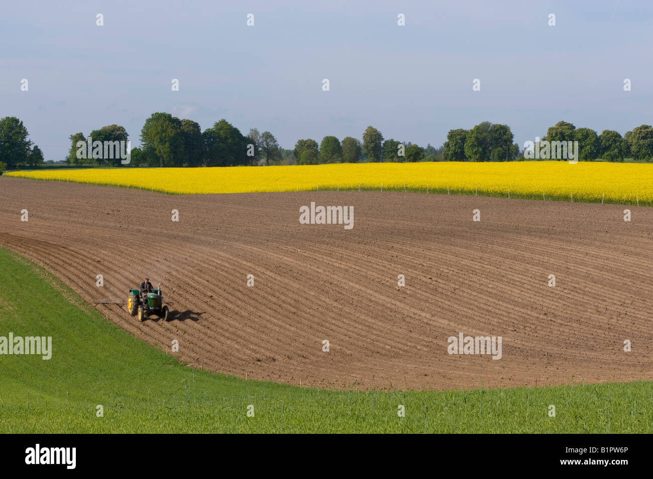 Farmer in a tractor cultivating his land Kaszuby region Poland Stock ...