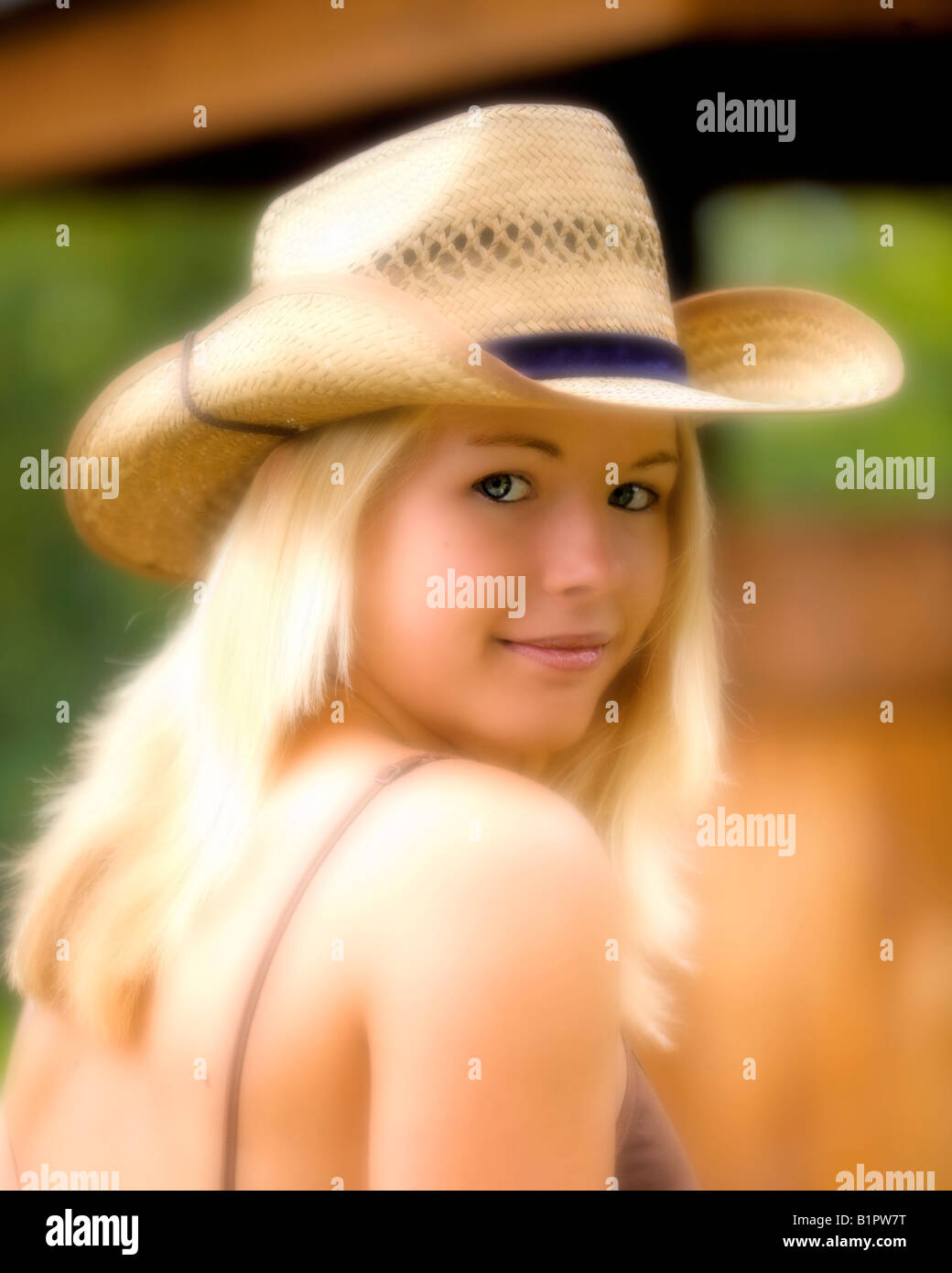 Image of a blonde Caucasian teenage girl looking back over her shoulder ...