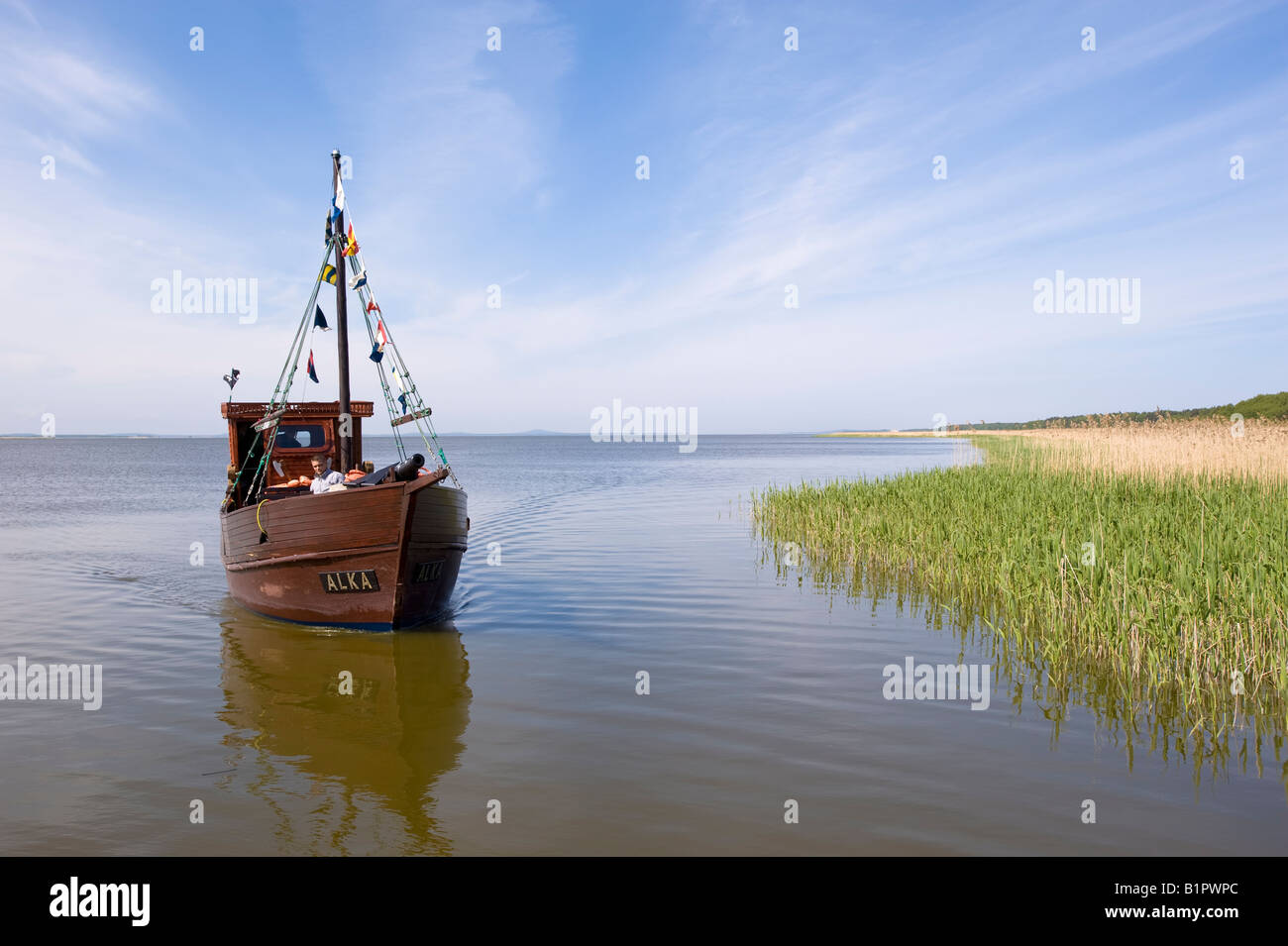 Tourists in leisure boat crossing Lebskie Lake near Leba Slowinski ...