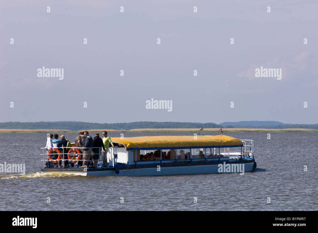 Tourists in leisure boat crossing Lebskie Lake near Leba Slowinski ...