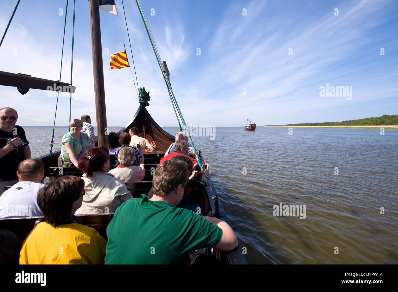 Tourists in leisure boat crossing Lebskie Lake near Leba Slowinski ...