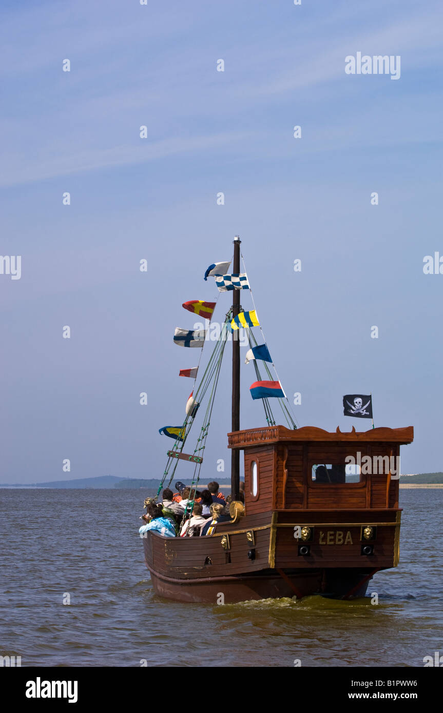 Tourists in leisure boat crossing Lebskie Lake near Leba Slowinski ...