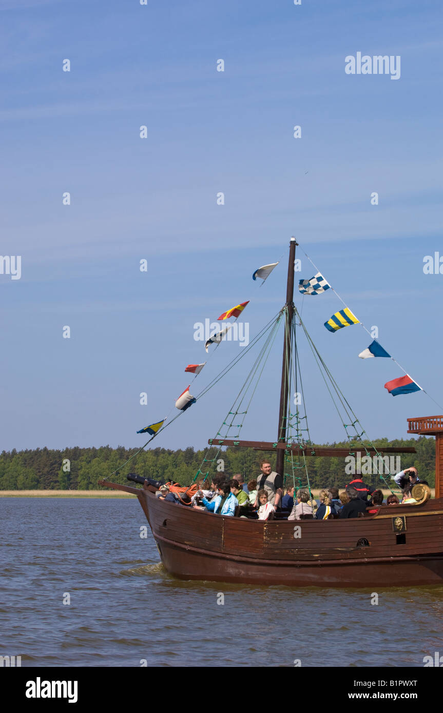 Tourists in leisure boat crossing Lebskie Lake near Leba Slowinski ...