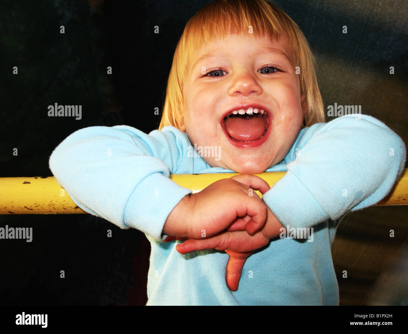 Child in playground laughing Stock Photo - Alamy