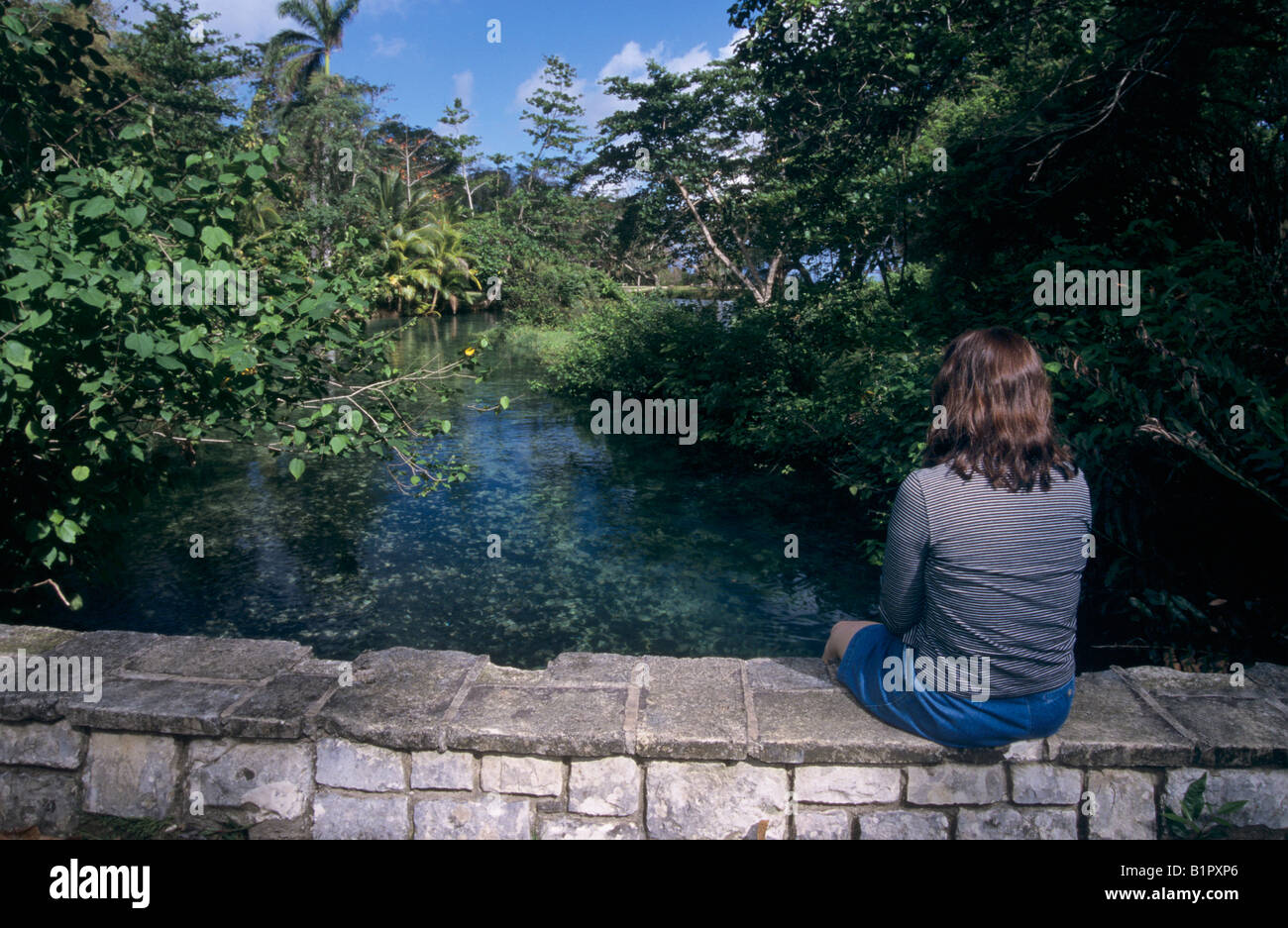Tourist sitting on rock bridge Frenchman s Cove Port Antonio Jamaica ...