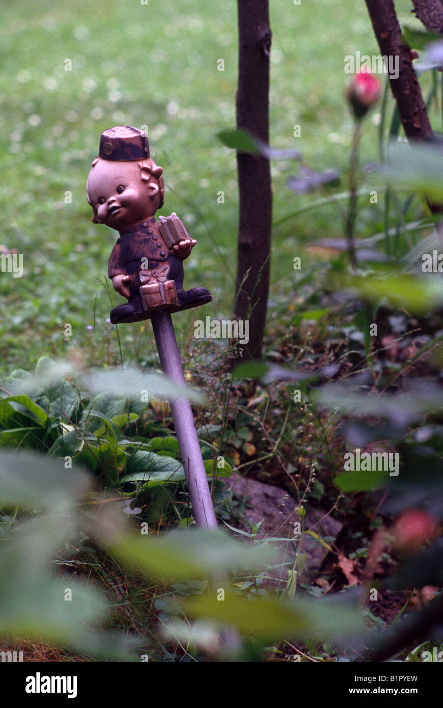 Small statue in garden Stock Photo - Alamy