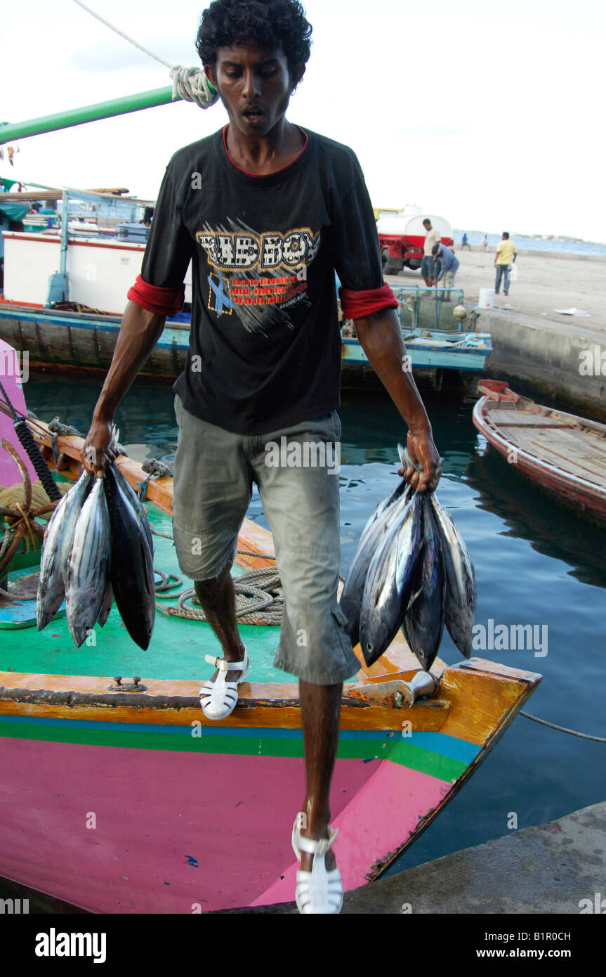 man brings fish Stock Photo - Alamy