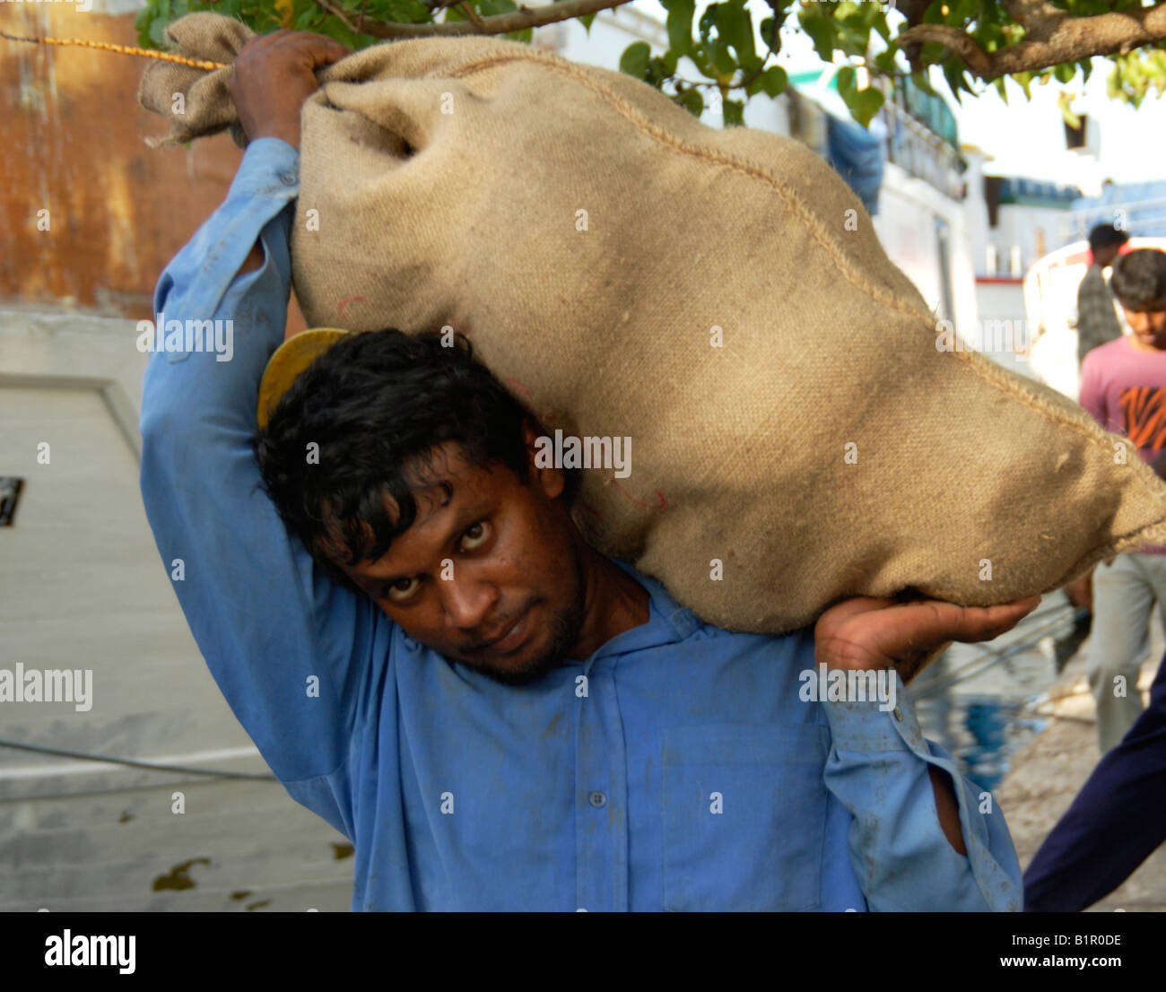 man carries goods on shoulders Stock Photo - Alamy