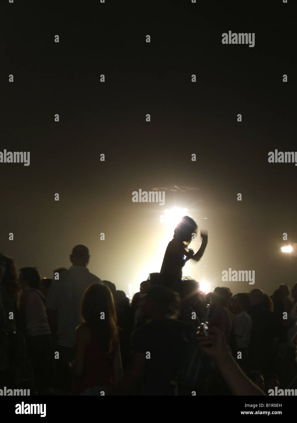 crowd of revellers at music concert gig at night Stock Photo - Alamy