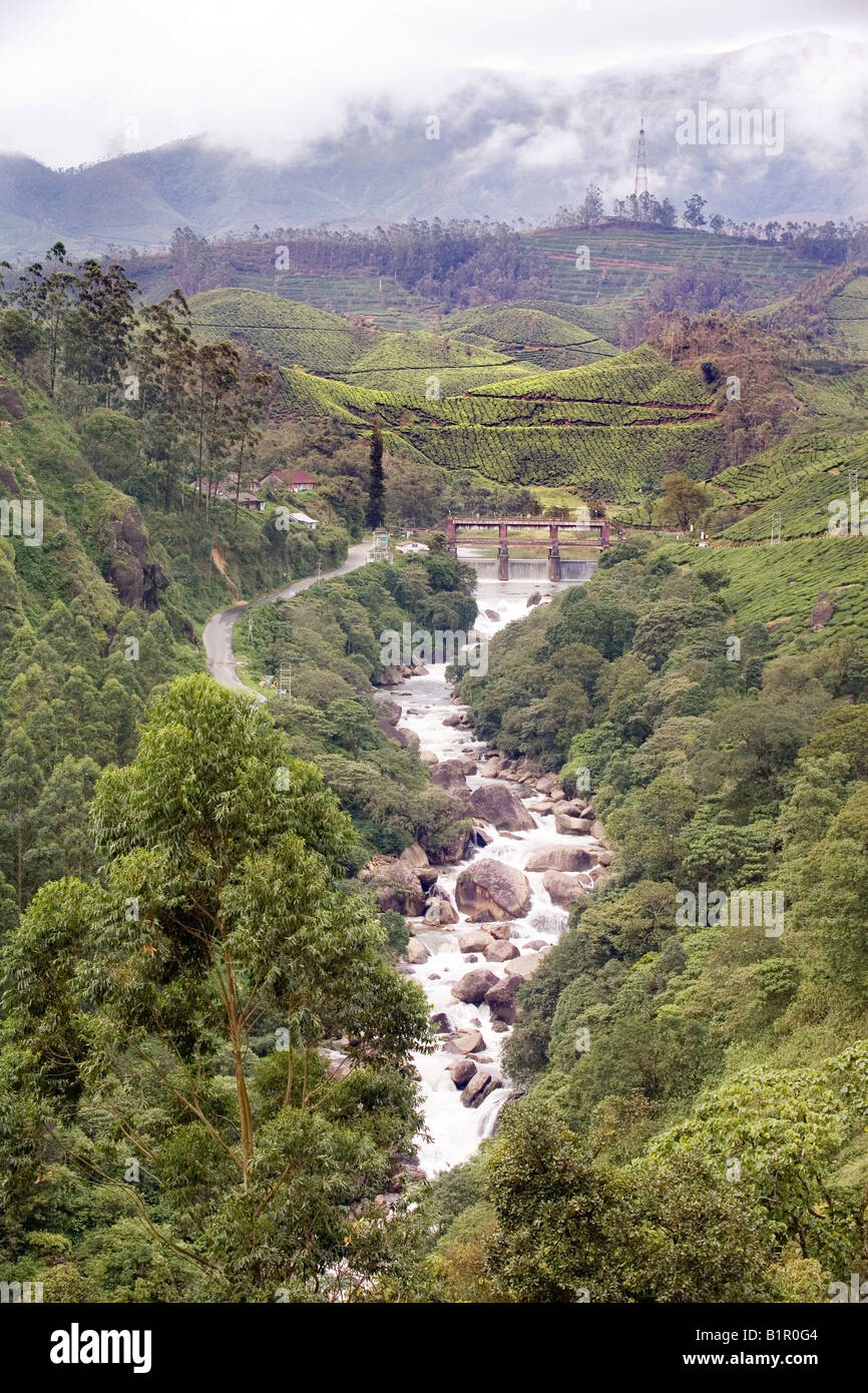 A mountain stream runs through a lush valley surrounded by undulating ...