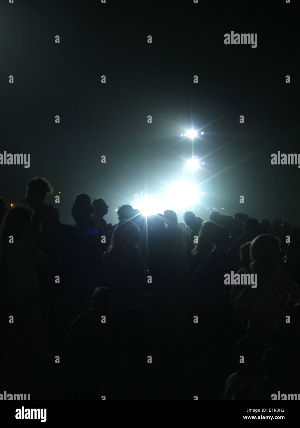 crowd of revellers at music concert gig at night Stock Photo - Alamy