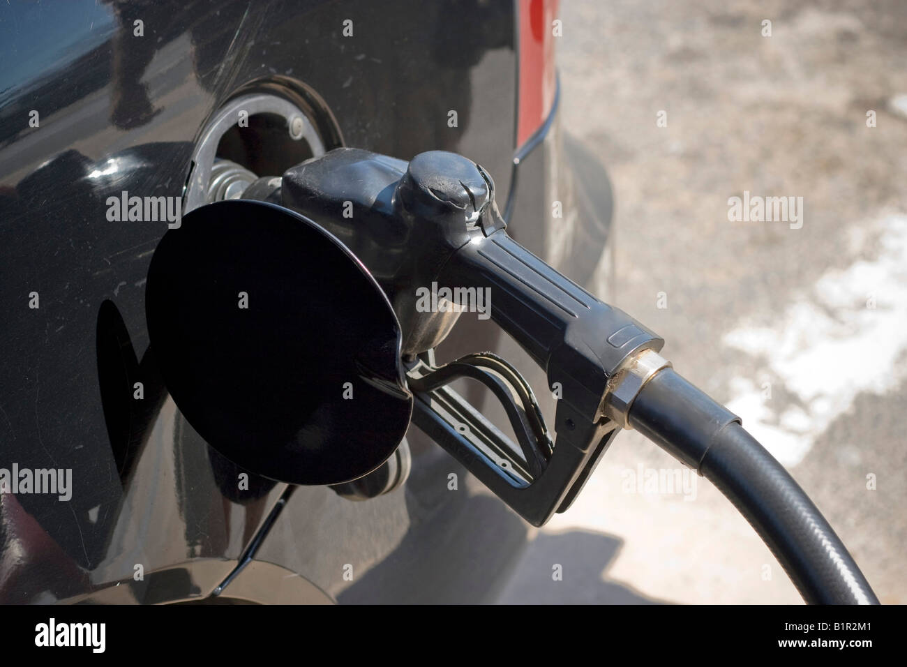At the gas pump filling up the tank Stock Photo - Alamy