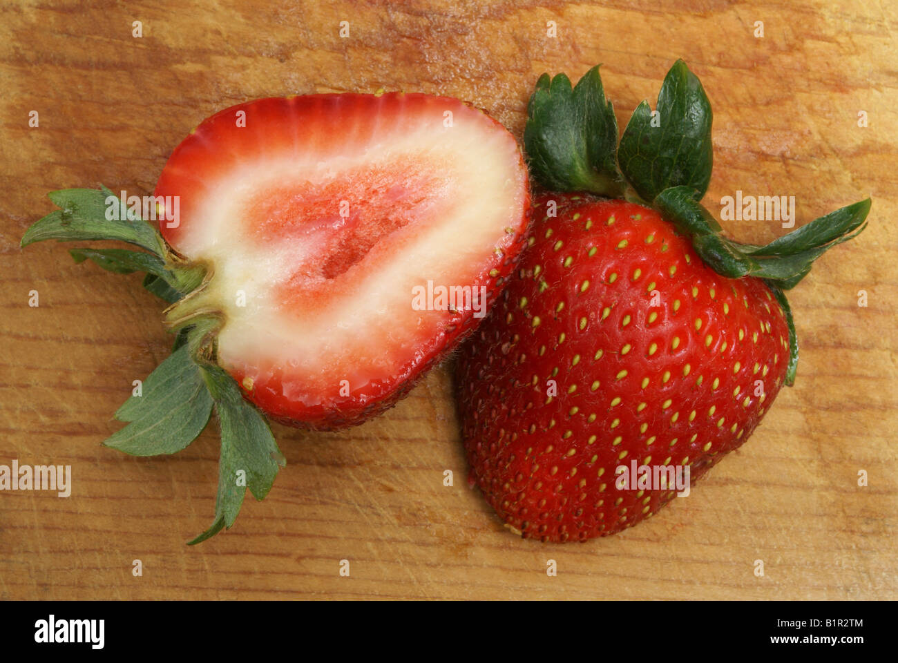 Ripe strawberry cut in half Stock Photo - Alamy
