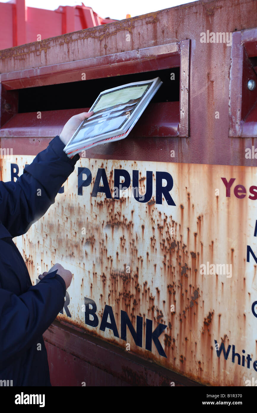 RECYCLING USING A PAPER BANK TO DISPOSE OF MAGAZINES Stock Photo - Alamy