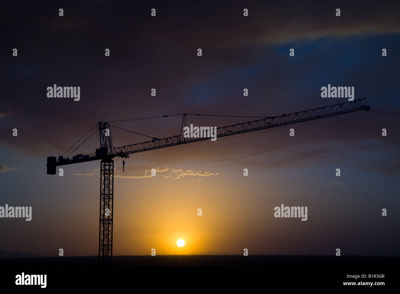 Sunset behind a crane Stock Photo - Alamy
