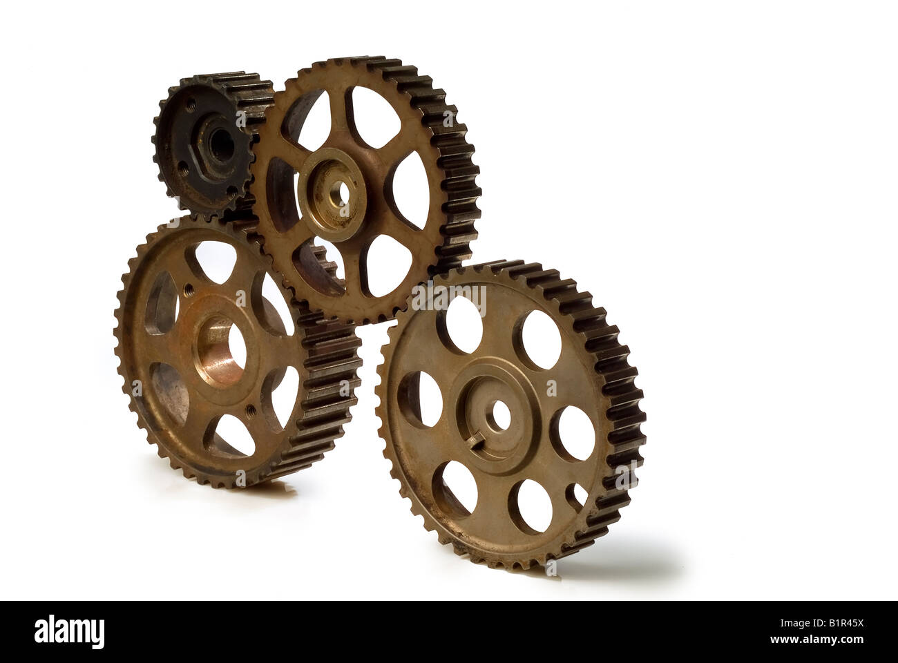 four cogwheels isolated on white Stock Photo - Alamy