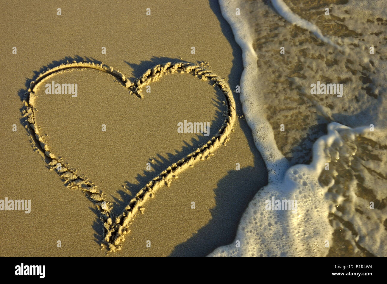 Heart in the sand Stock Photo - Alamy