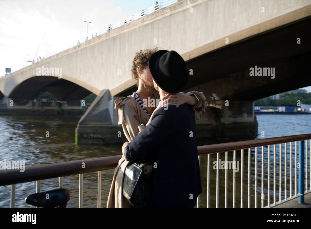Couple kissing along the riverbank London England Britain UK Stock ...