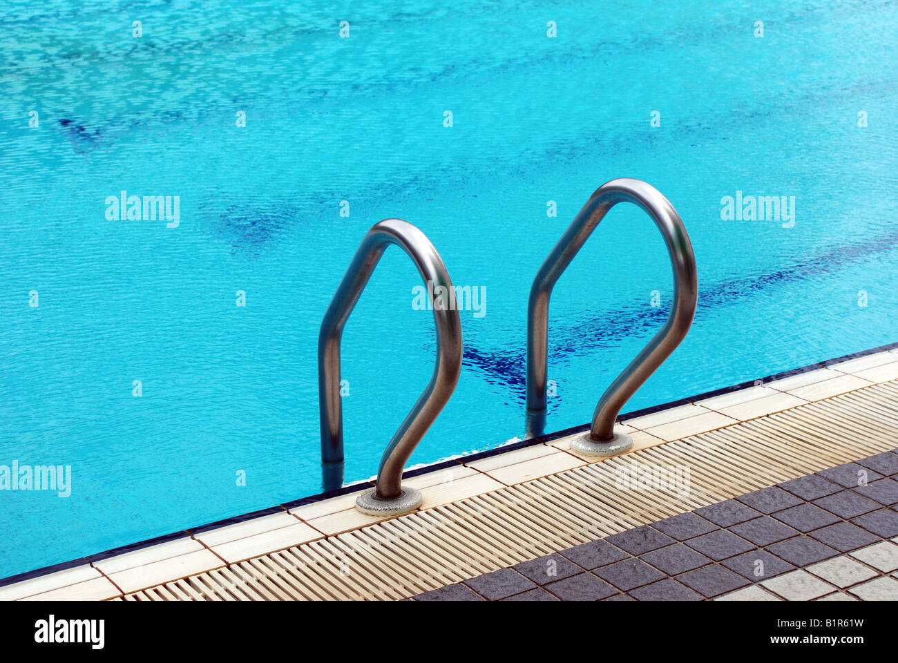 Swimming pool handrail at edge Stock Photo - Alamy