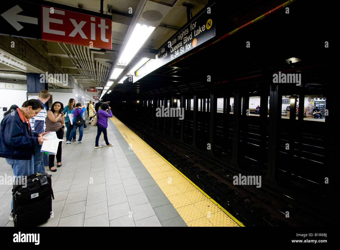 Passengers wait for a train at the Prince Street subway station in New ...
