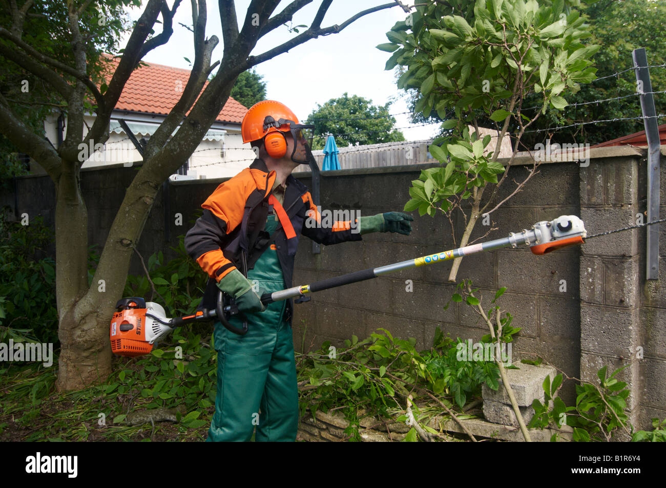 Man in full protective STIHL power tool clothing using a Combi Engine ...