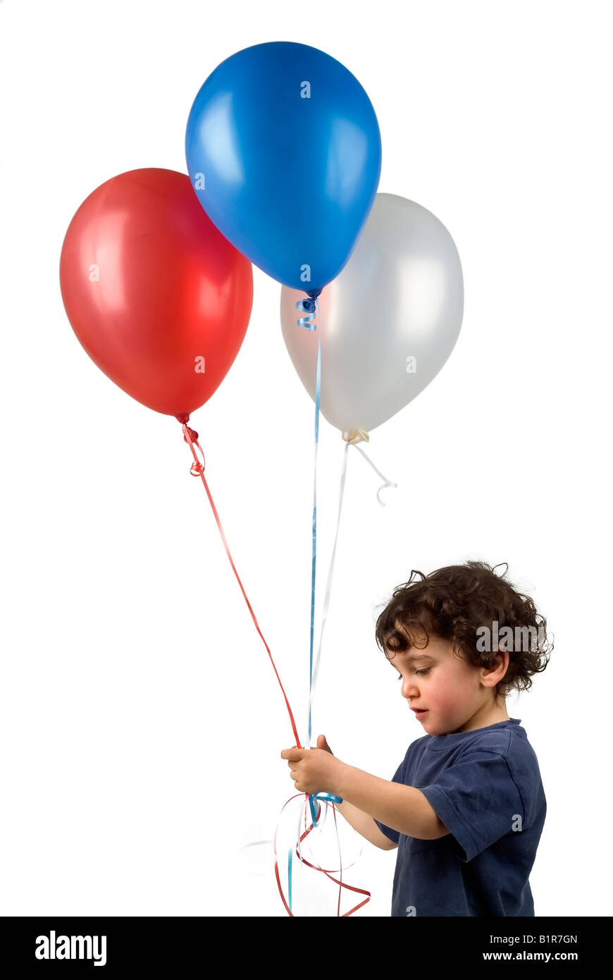 little boy holding 3 balloons Stock Photo - Alamy