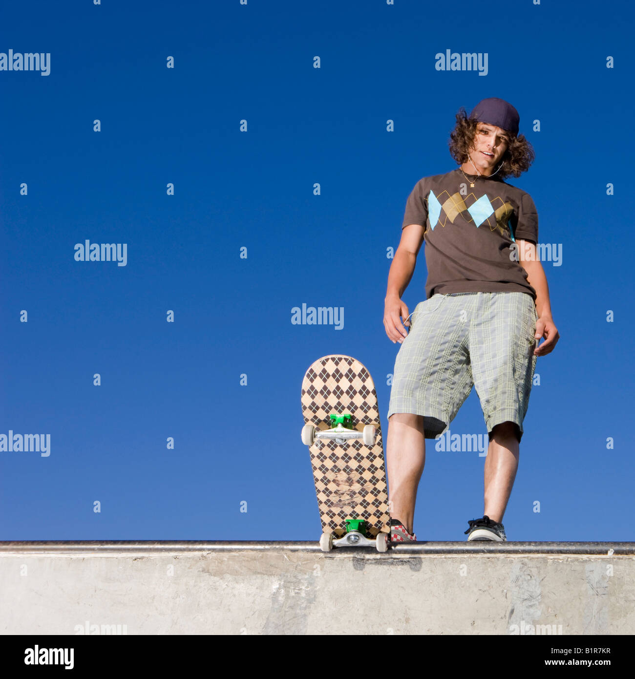 Skateboarder at top of half pipe Stock Photo - Alamy