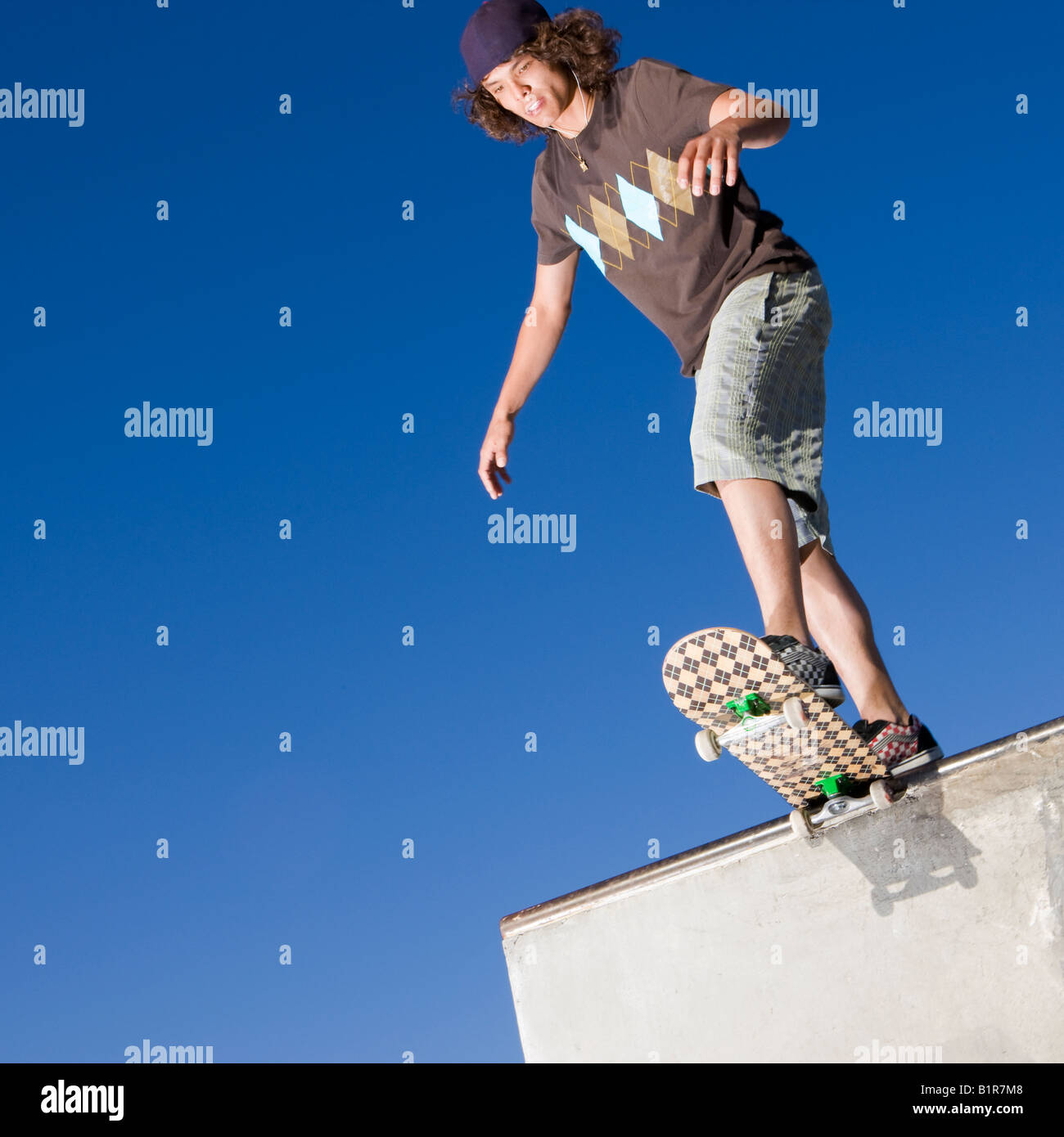 Teen boy does tricks in the half pipe at a skate park Stock Photo - Alamy