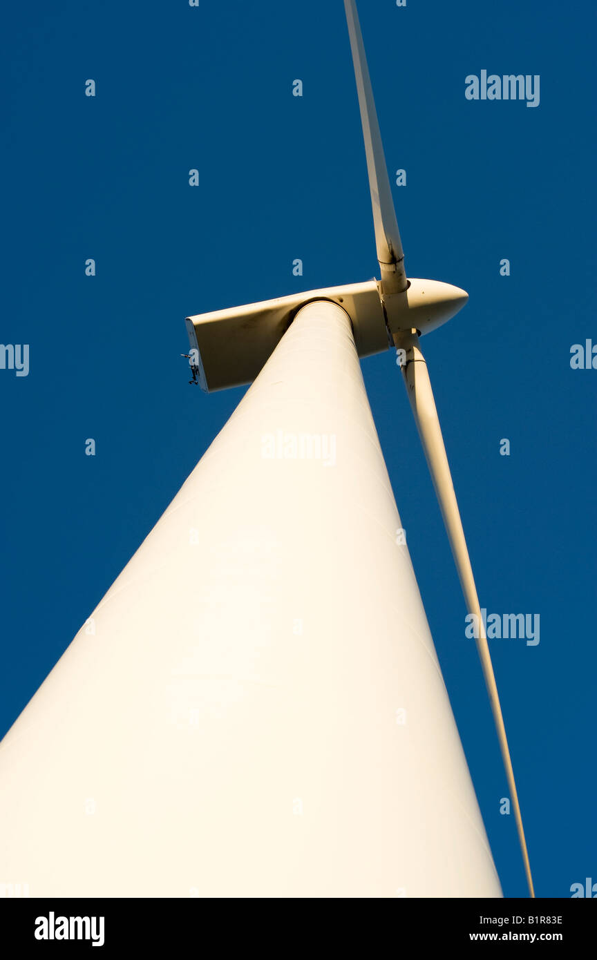 Looking up to the rotor blades of a Wind Turbine against a blue sky ...