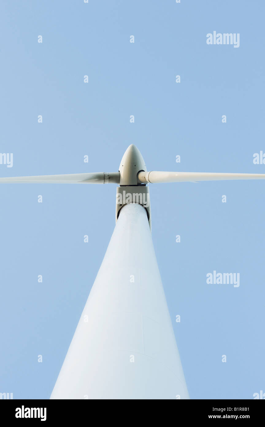 Looking up to the rotor blades of a Wind Turbine against a blue sky ...