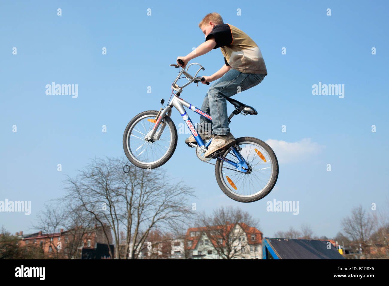 young biker jumping with his bicycle Stock Photo - Alamy