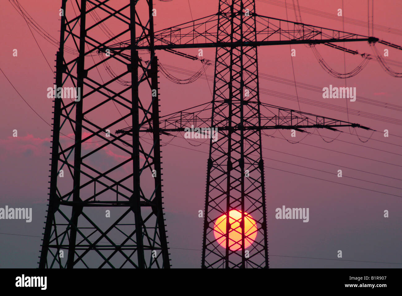 pylons in front of the setting sun Stock Photo - Alamy