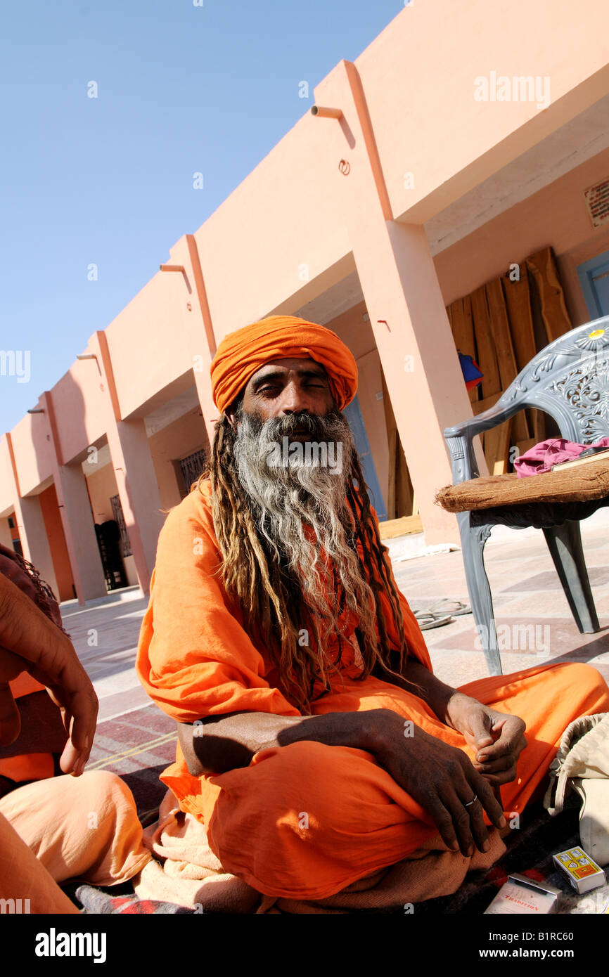 A colorful Sadhu sits on the floor of his Ashram in Rajasthan,India ...