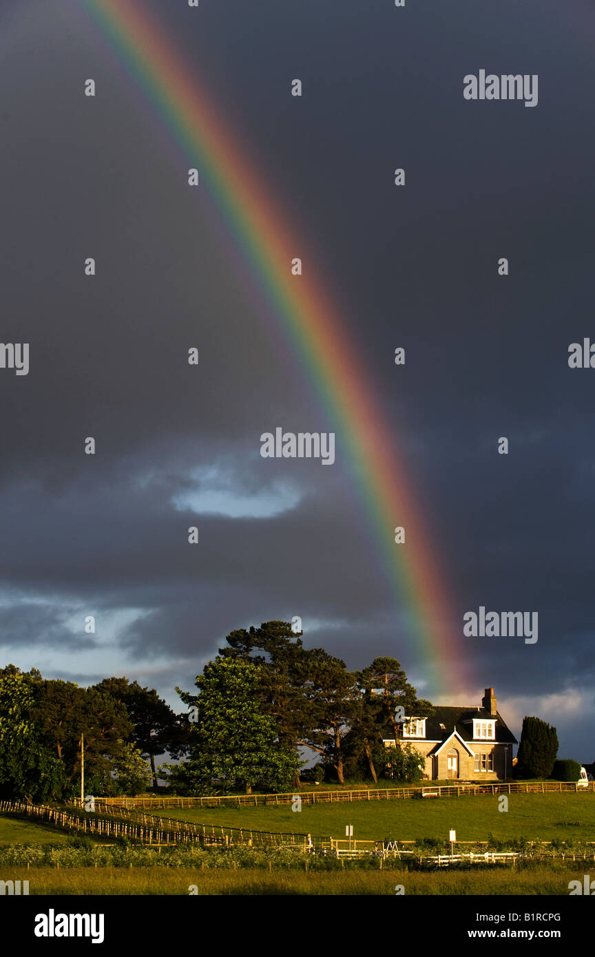 Rainbow and rainclouds over a scottish farmhouse. Moray, Scotland Stock ...