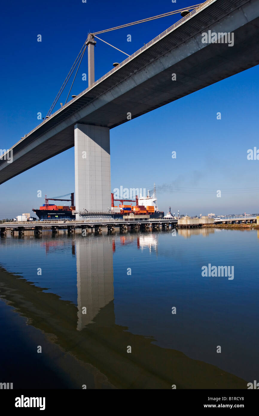 Shipping Industry / A Container Ship is inbound and passes under the ...