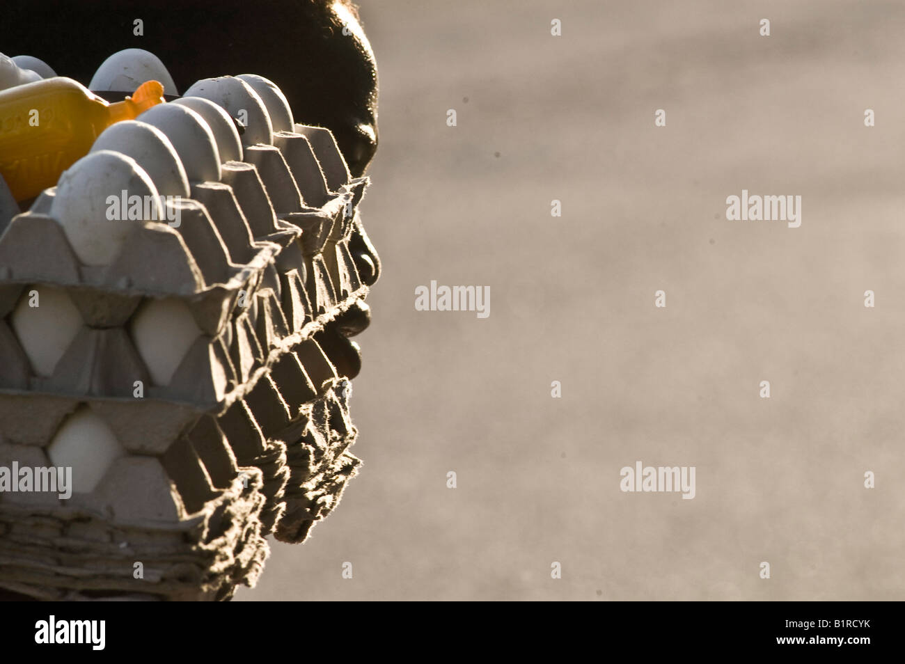 Black man carrying an egg crate Stock Photo - Alamy