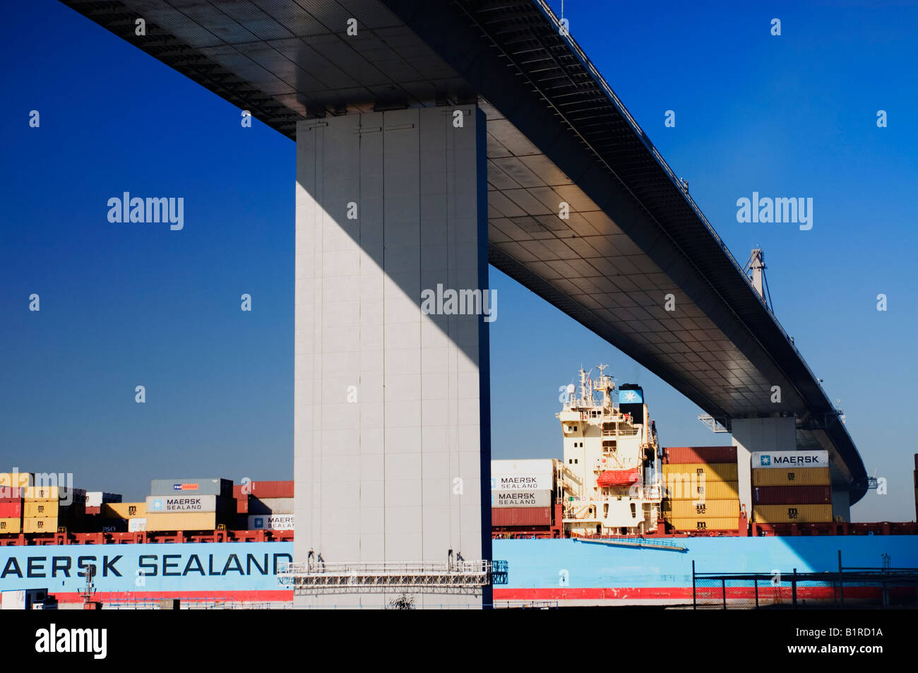 Shipping Industry / A Container Ship is inbound and passes under the ...