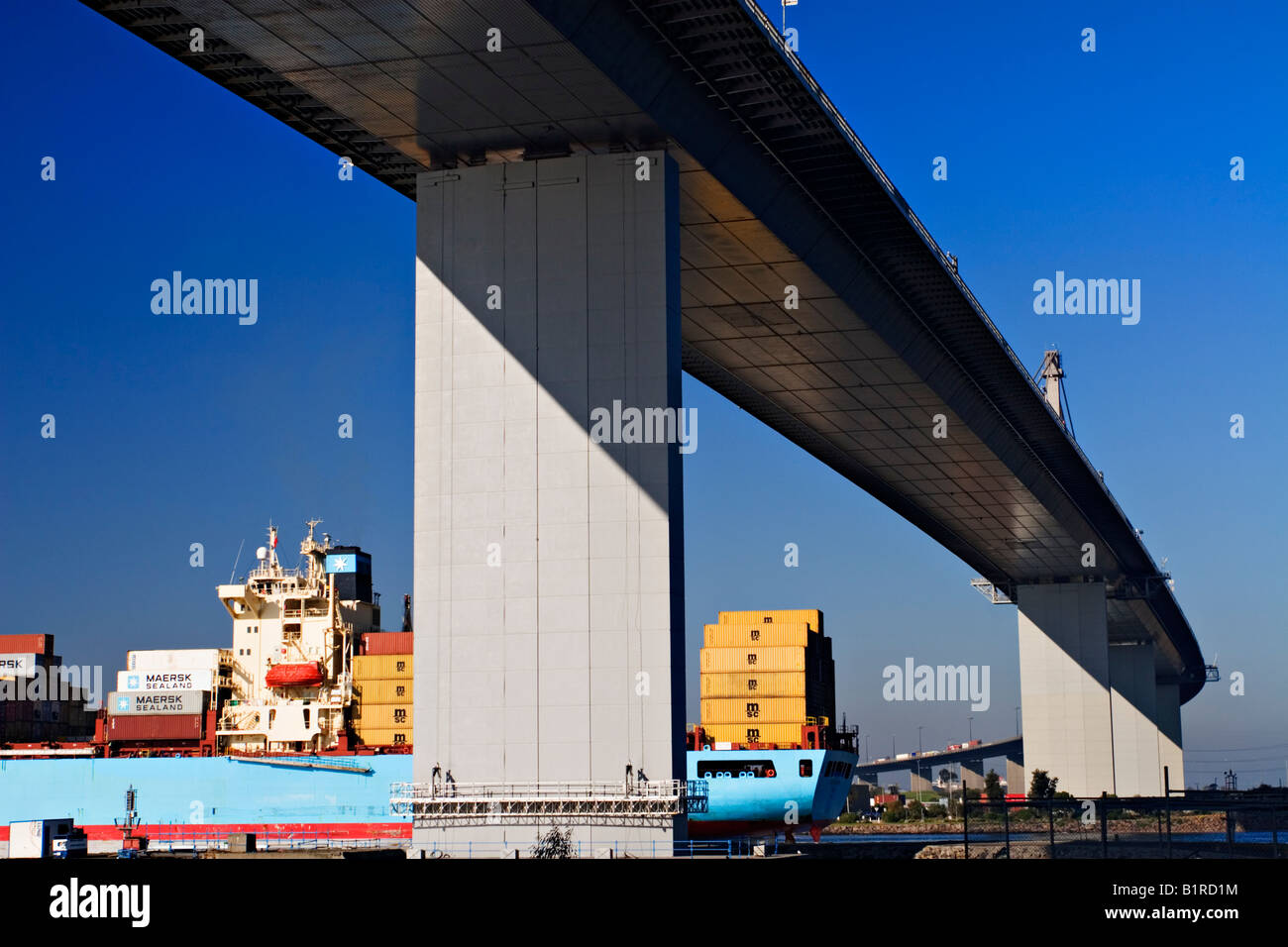 Shipping Industry / A Container Ship is inbound and passes under the ...